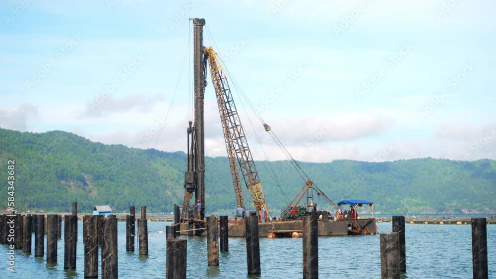 Drilling piles in water using a drilling rig on a platform on water ...