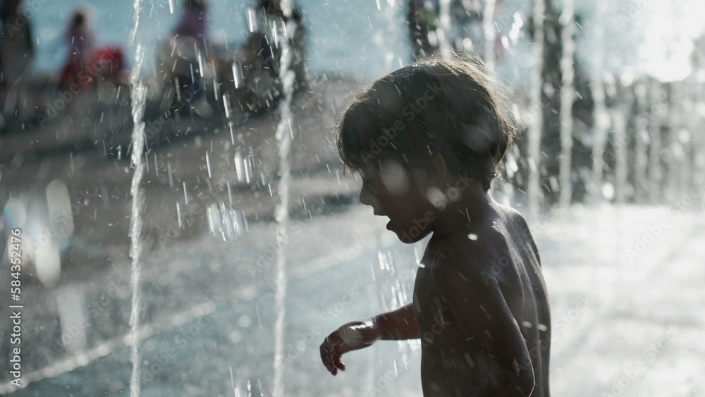 Child running into water park jets in super slow motion 120fps. Happy ...
