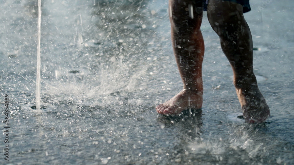 Child feet in splashing water playing at park water jet outdoors Stock ...