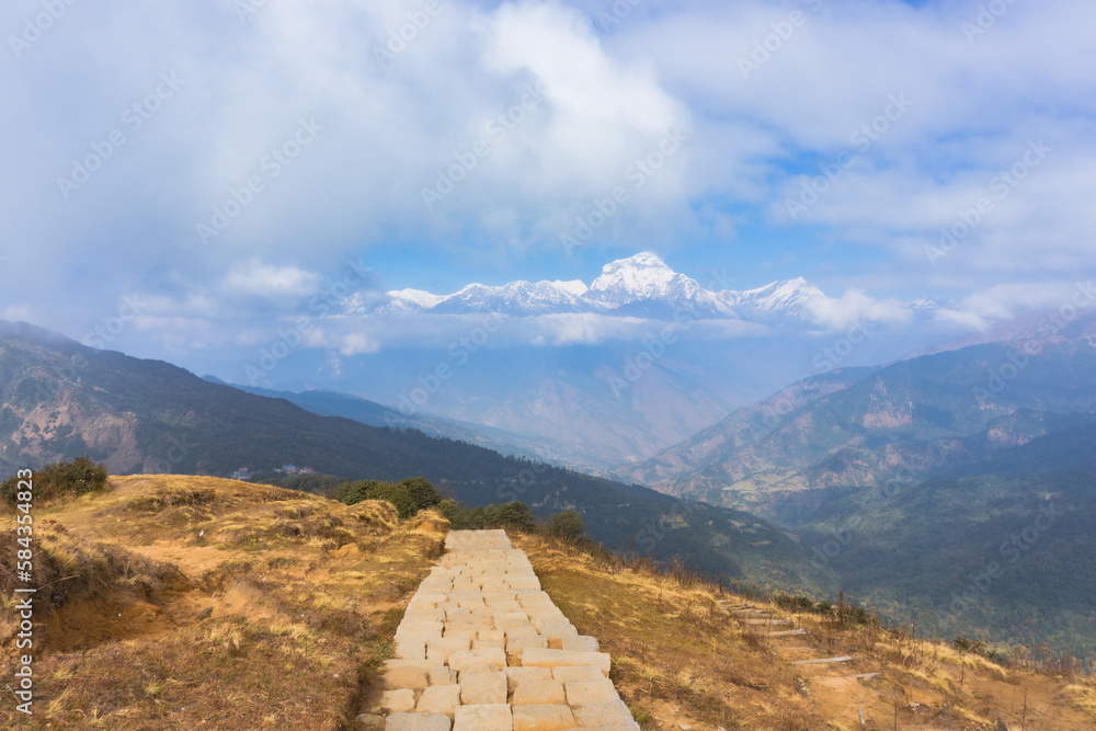 View of footway and countryside in Annapurna Base Camp Trek with Annapurna Mountain Range at ...