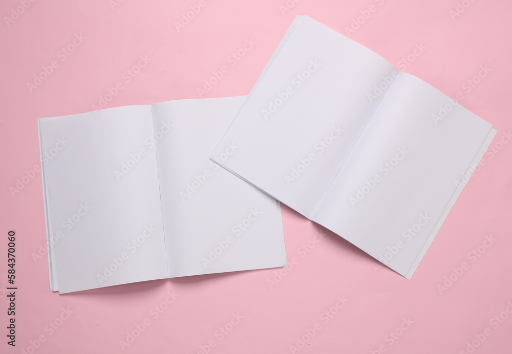 Mockup of two open magazines with white open pages on pink background ...