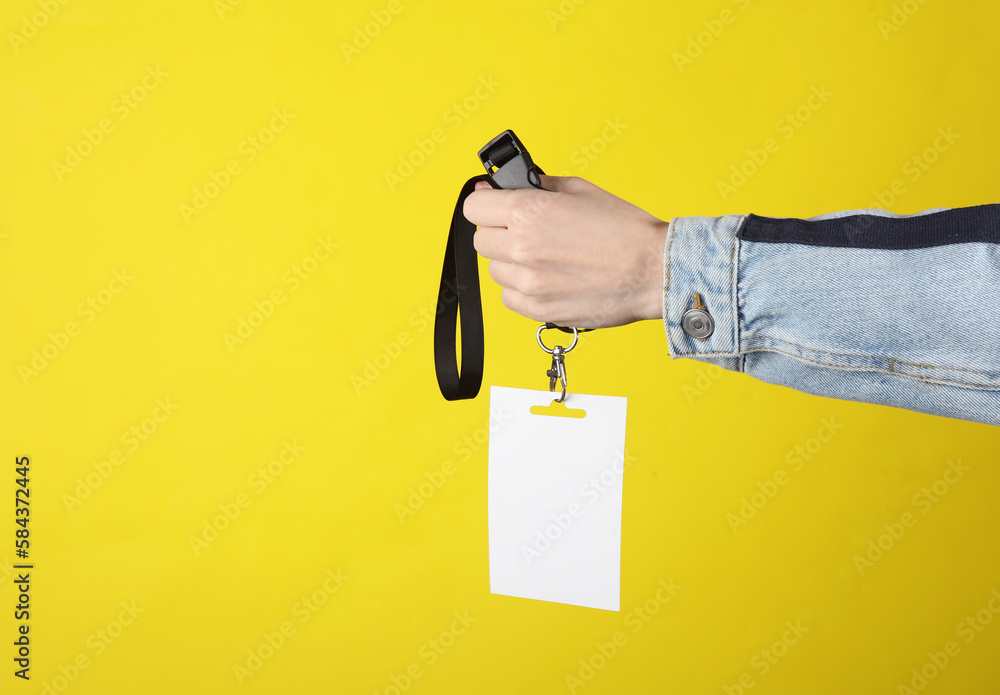 Hand holding Identification white blank id card on yellow background ...