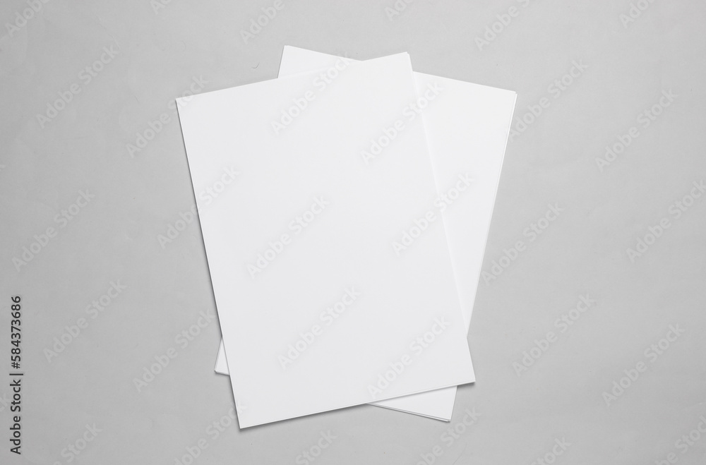 White blank sheets of a4 paper size or documents mockup on a gray ...