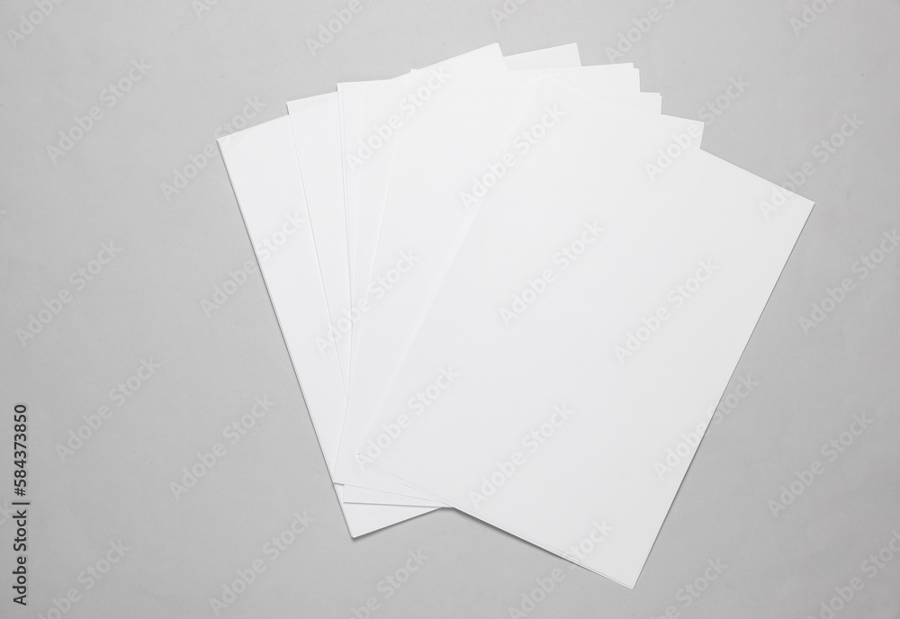 White blank sheets of a4 paper size or documents mockup on a gray ...