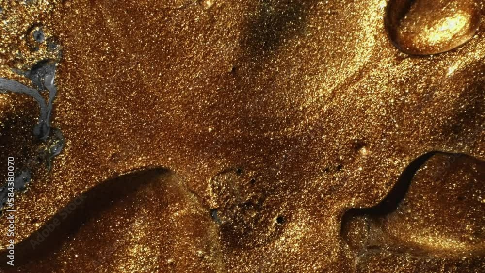 Sparkling fluid. Paint flow. Glamour liquid. Defocused shiny bronze ...