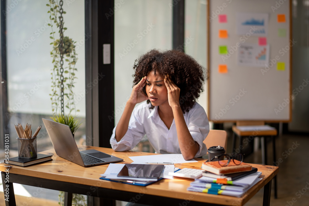 Black woman working on a computer screen and stressed out about the ...