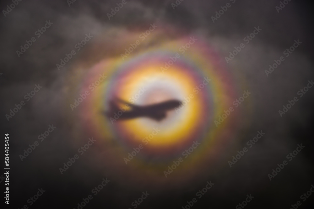 optical phenomenon called a glory, cast onto clouds below a plane in ...