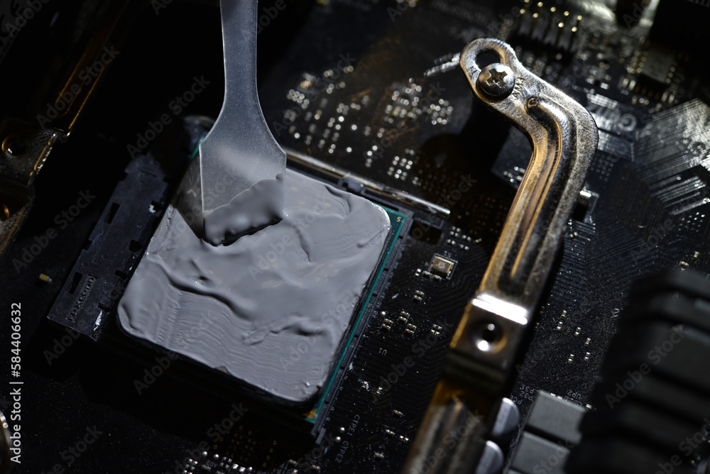 Applying thermal paste to the surface of the computer processor ...