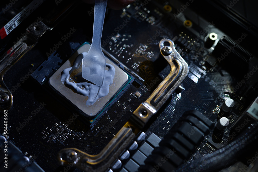 Applying thermal paste to the surface of the computer processor ...