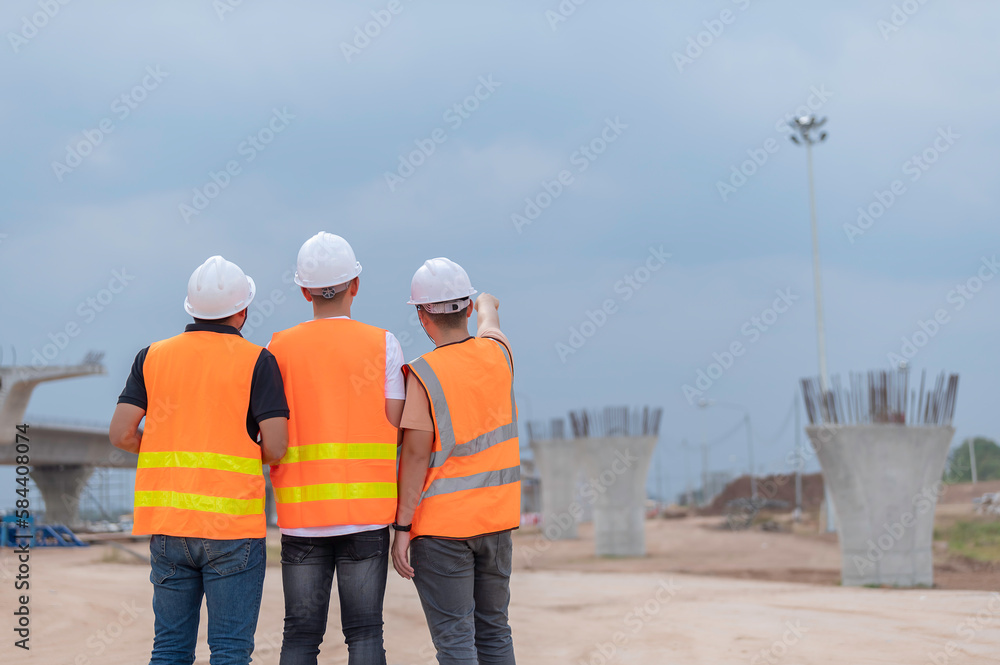 Group of asian engineers discuss about work at site of building under ...
