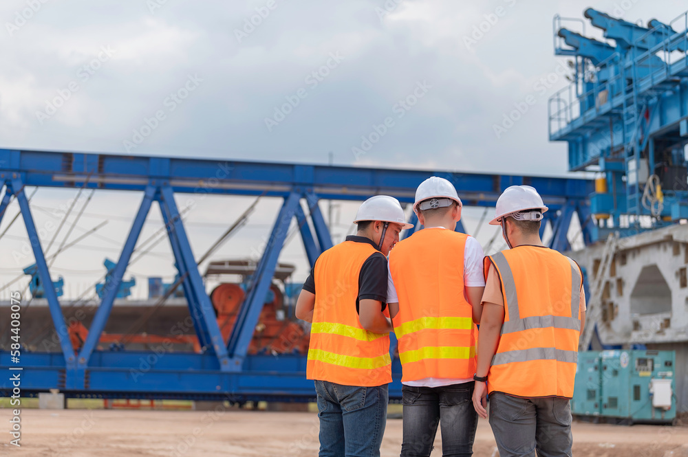Group of asian engineers discuss about work at site of building under ...