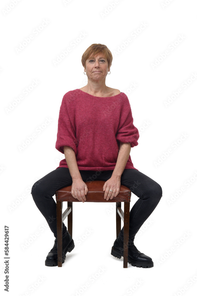 front view of a woman in tight jean pants sitting on chair looking at ...
