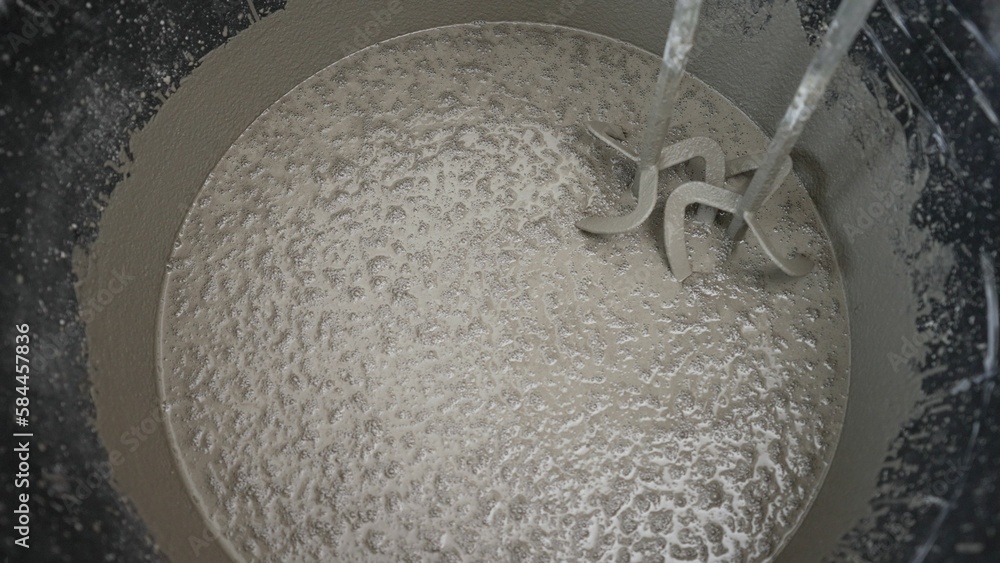 Mixing concrete. A bucket of gray mixing and mixing solution for on ...