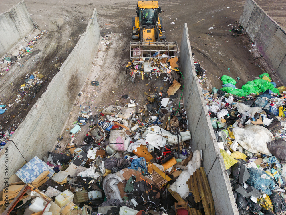 Wheeled loader loading bucket with garbage material and moving it ...