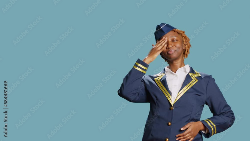 African american stewardess yawning in studio, being tired and worn out ...