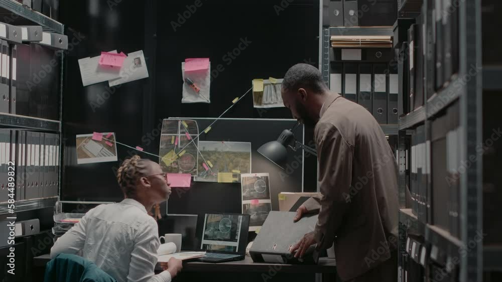 Private detectives checking crime scene photos on map, working to find ...