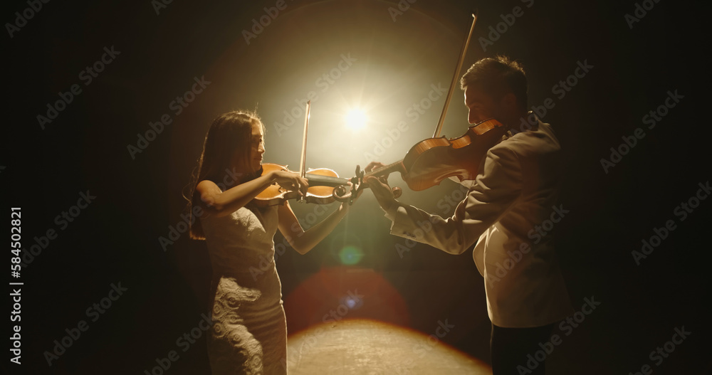 Duet of two professional violin players having a solo together ...