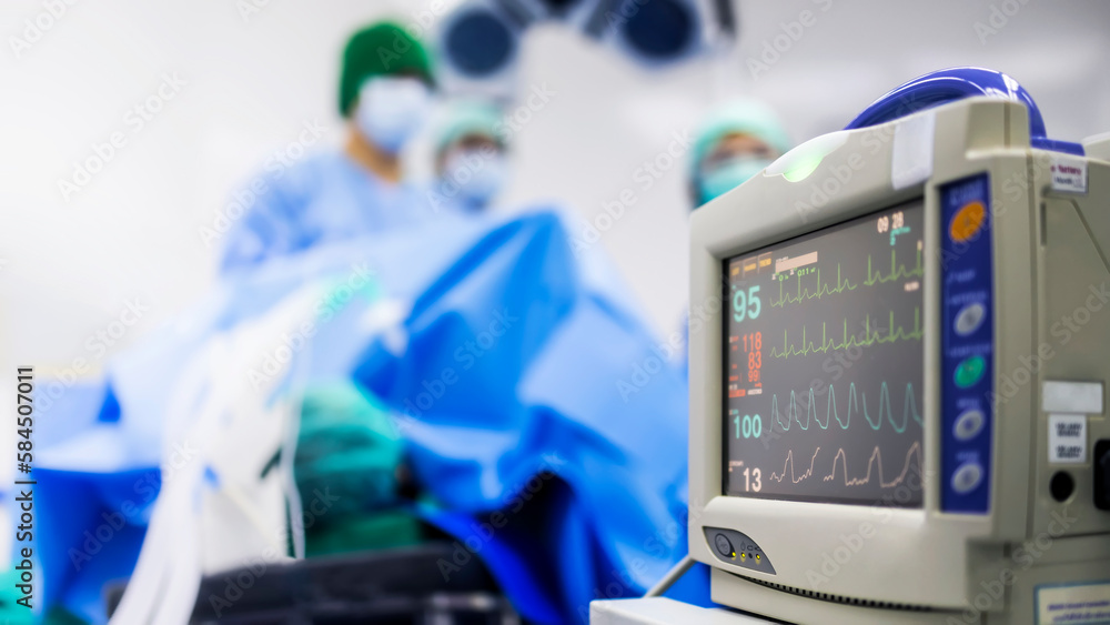 Monitor screen with vital sign and ECG data of patient during surgery ...