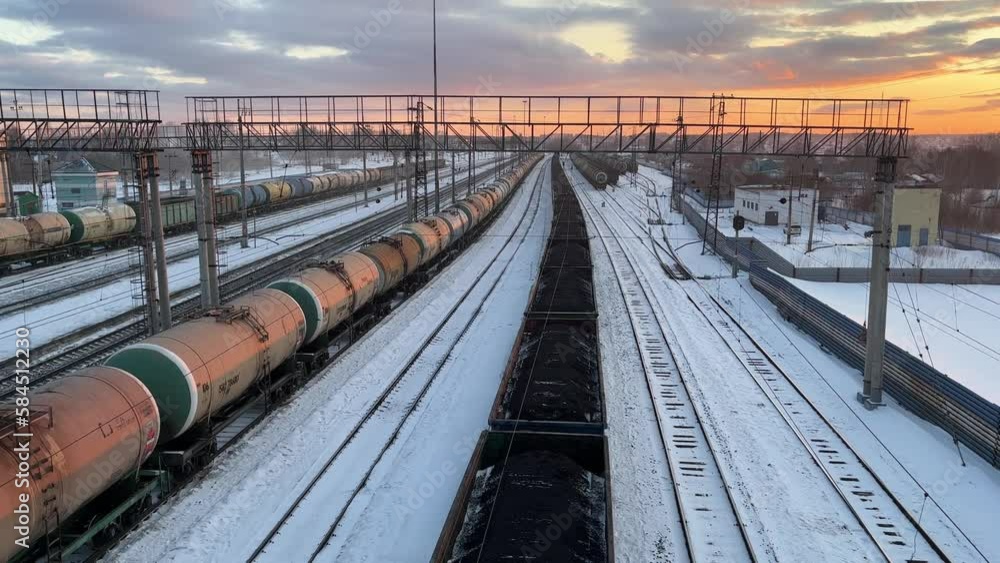 Railway station with freight trains at sunset in winter. The railway ...