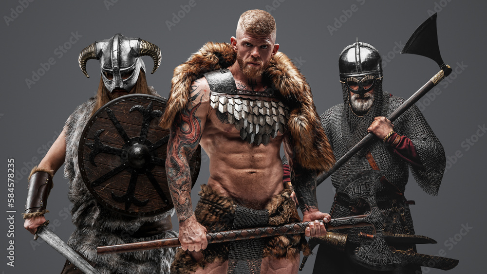 Portrait of antique vikings warriors with axes dressed in armor and fur ...