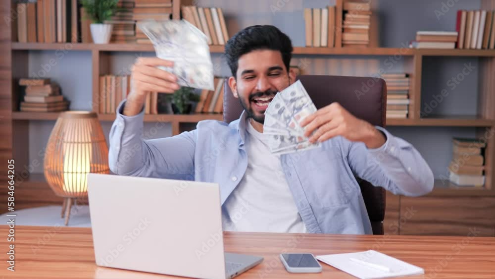 Funny cheerful indian rich man businessman guy waving money dollar cash ...