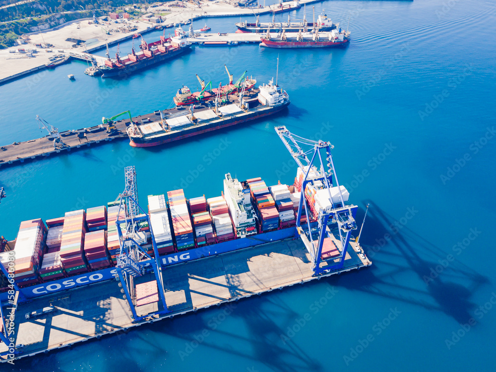 Container vessel of COSCO shipping company uploading in cargo port ...