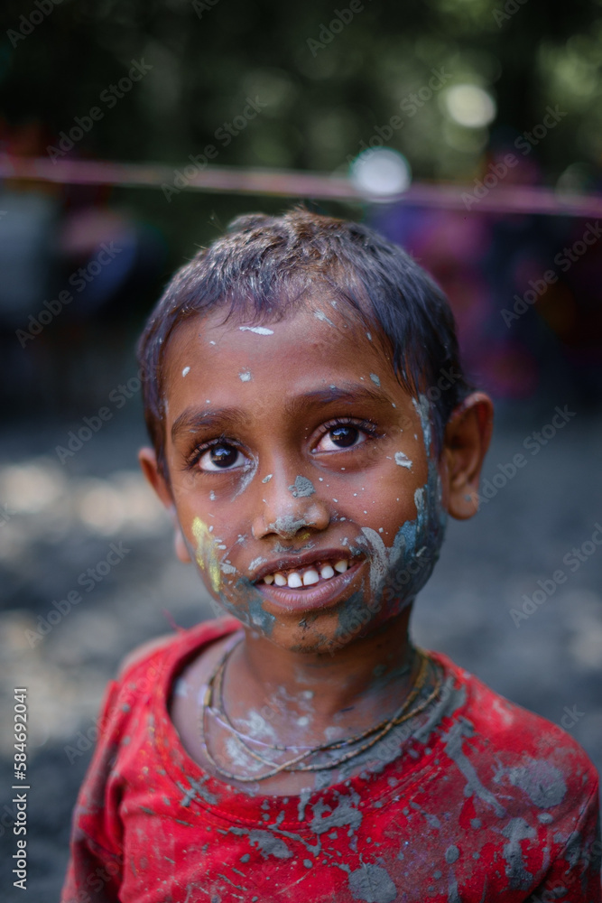 South asian hindu religious little boy enjoying holi festival,the ...