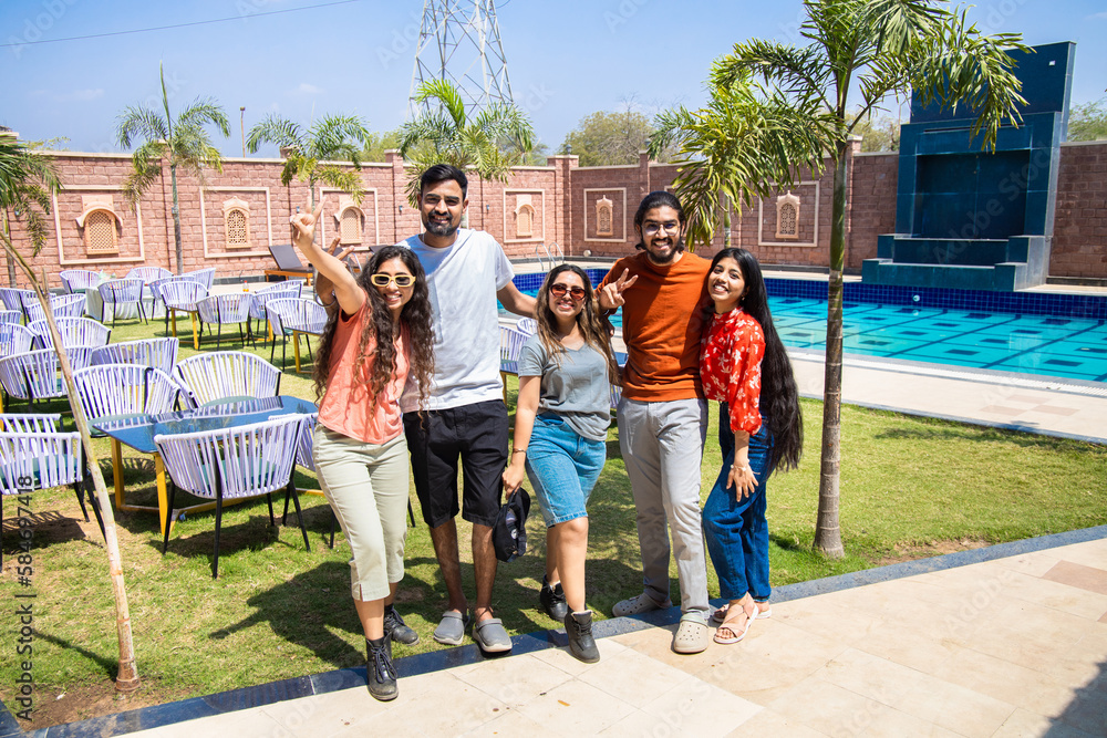 Group of young indian friends having fun standing at resort in hot ...