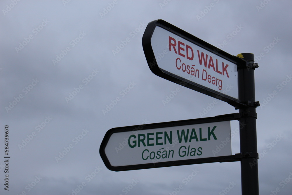 Trail signs in English and Irish Reading "RED WALK" and "GREEN WALK ...
