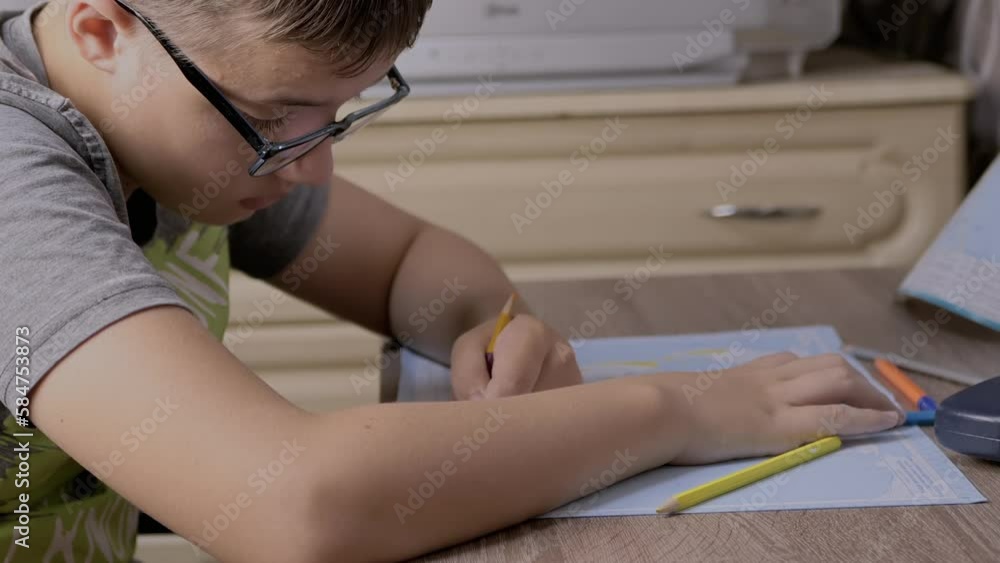 Serious Boy in Glasses Drawing Strokes on the World Map with a Pencil ...
