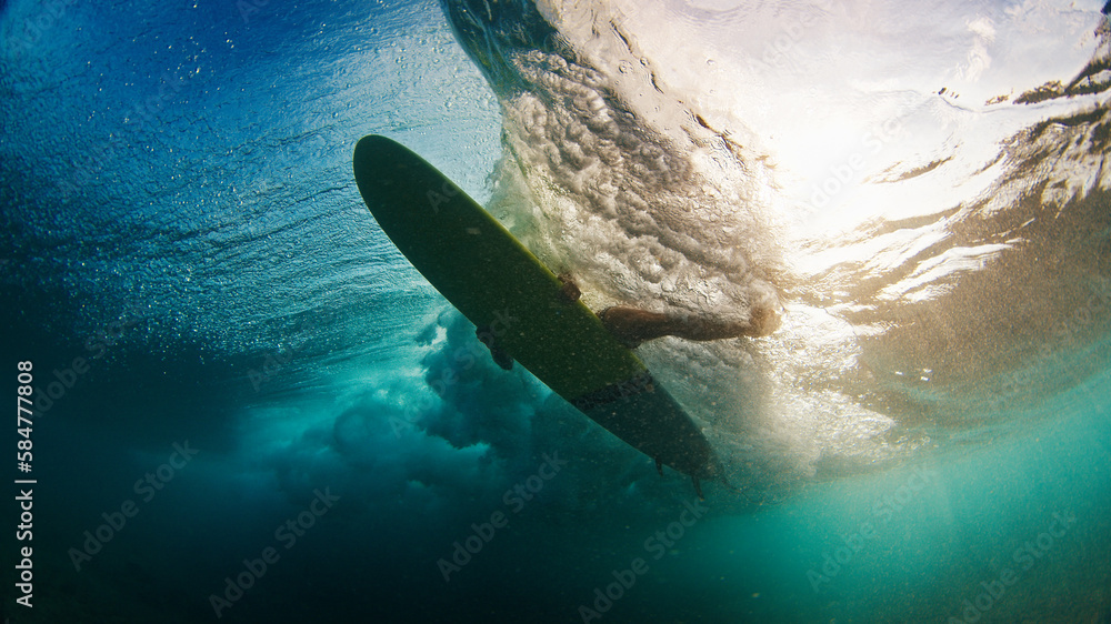 Surfer underwater. Young man in the ocean. Surfer paddles the surfboard ...
