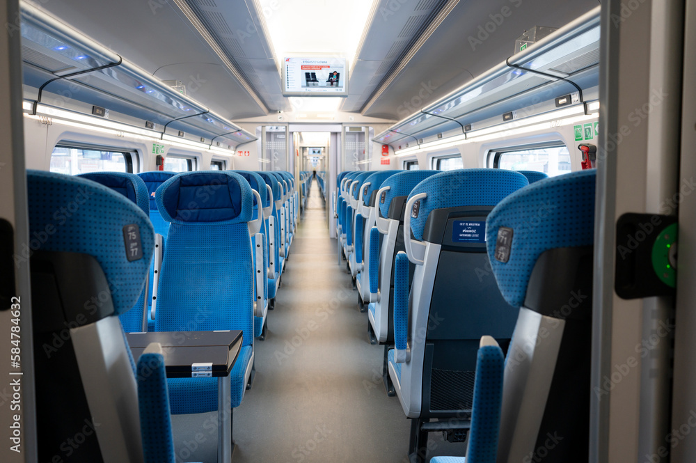 Empty cabin of a modern passenger train. Empty blue seats inside train ...