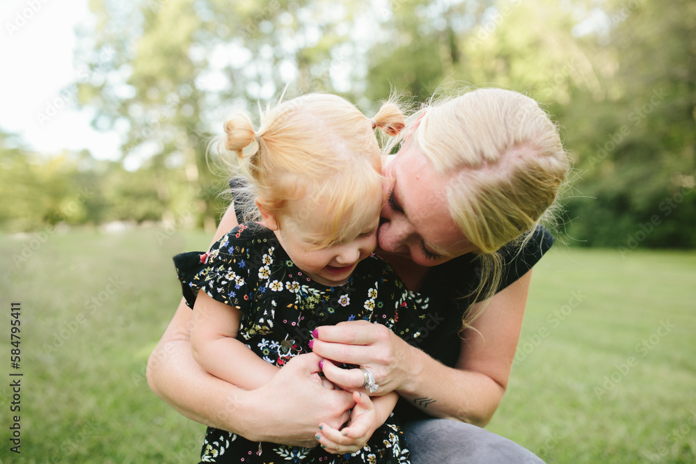 Mom hugs daughter close Stock Photo | Adobe Stock