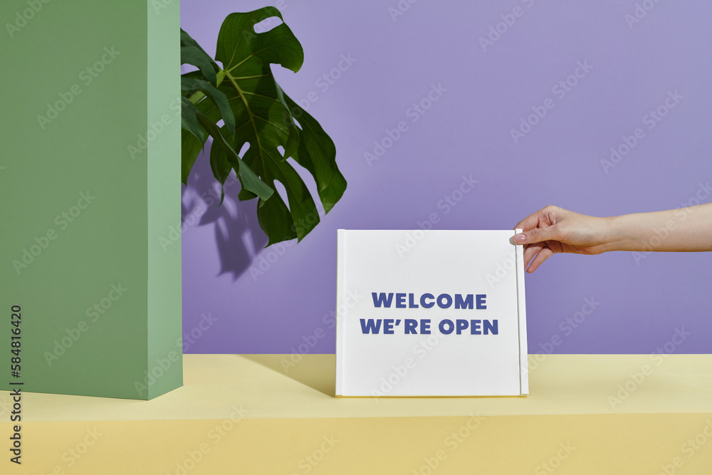 Welcome We're open sign on white board with potted plant Stock Photo ...