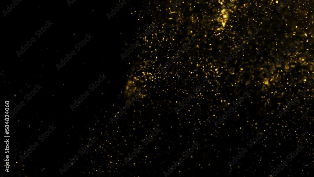 Gold dust particles fly in slow motion in the air lingering slowly ...