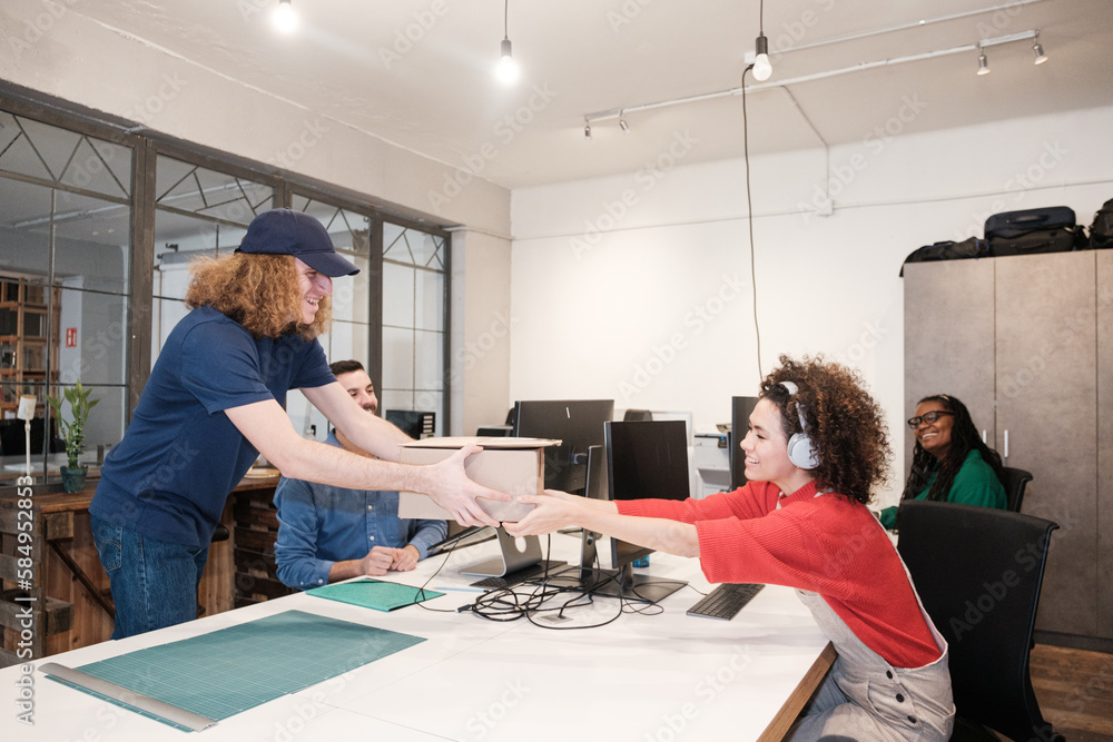 Courier Man Delivering Packages At Workplace Stock Photo Adobe Stock