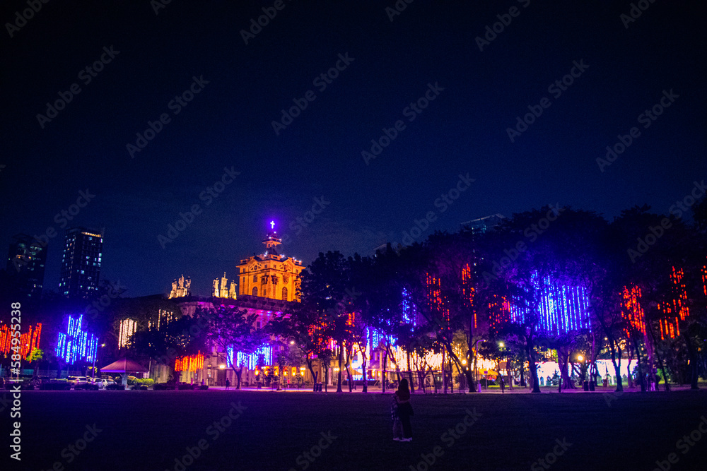 People hugging under Christmas lights in the city streets. University ...