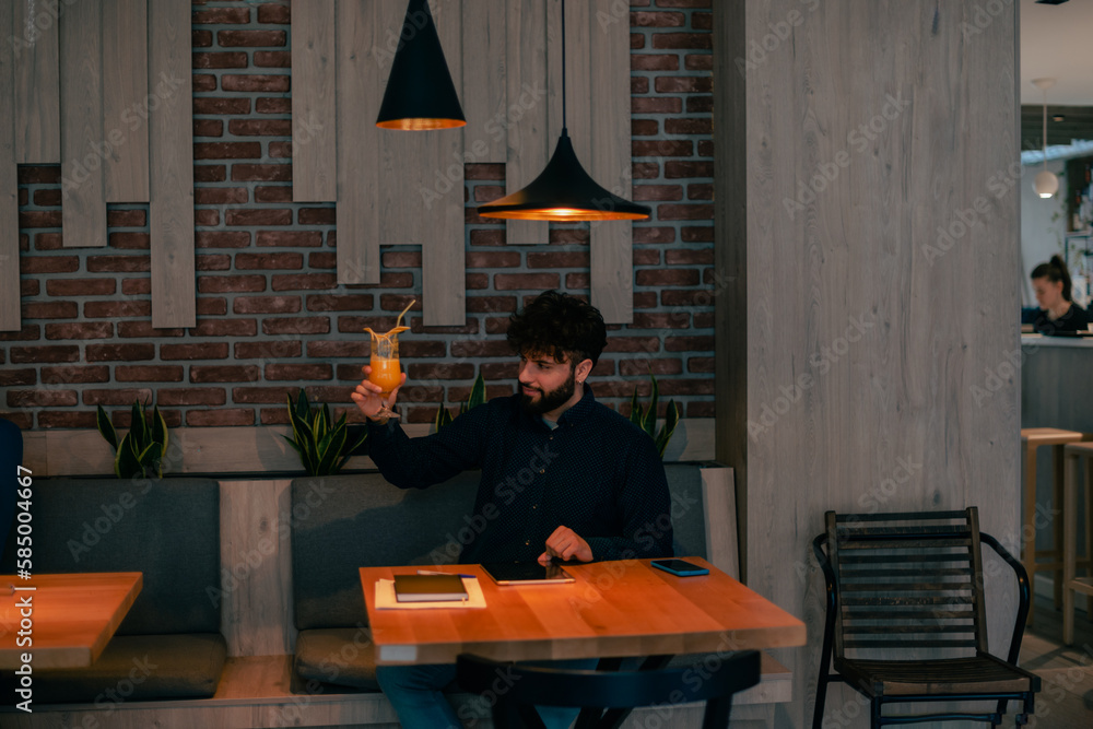 Handsome smiley businessman cheering his colleagues with a glass of ...