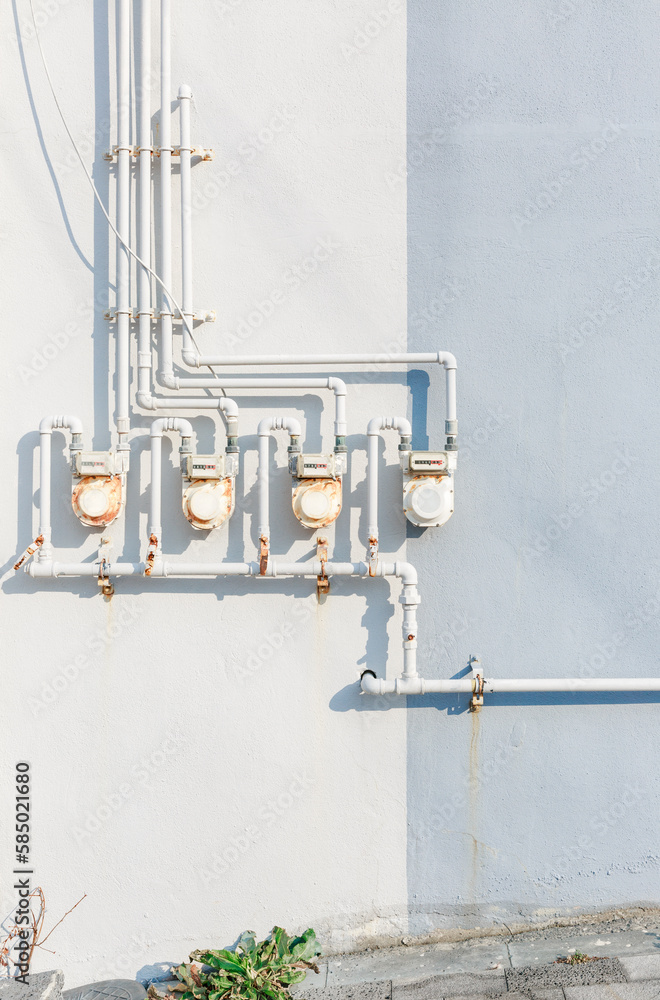 Gas pipeline installed on the wall of a sky-blue building. Stock Photo ...