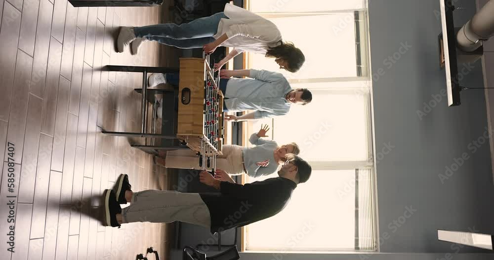 Excited cheerful male and female colleagues playing board game, table ...