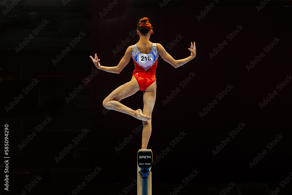 back female gymnast performing exercise balance beam on black ...