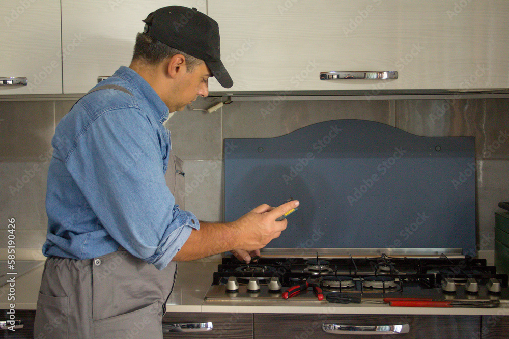 Image of a handyman technician who with a detector carries out checks ...