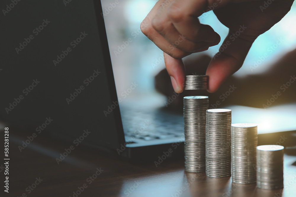 Hand place coins stack in graph shape for real estate or money savings ...