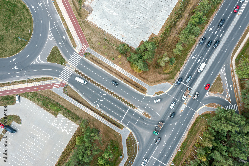 aerial photo of a roundabout with road intersection in suburb area ...