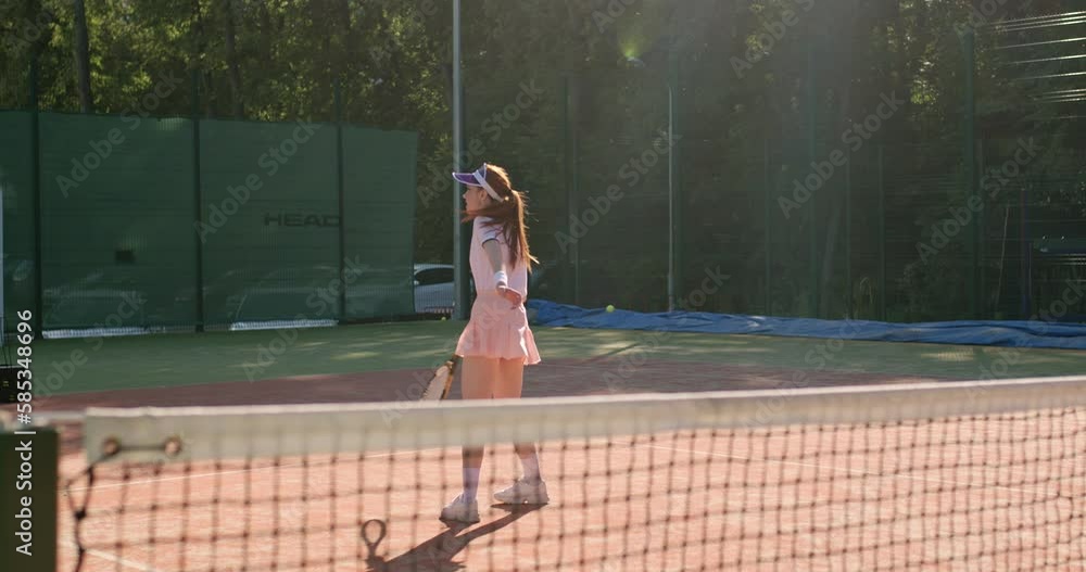 Female tennis player with red hair running, trying to hit ball, missing ...