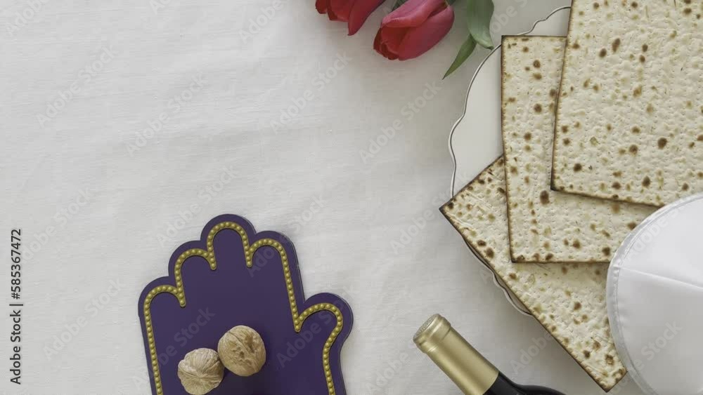 Matzah shape of heart with red tulips, bottle of wine and walnut on ...