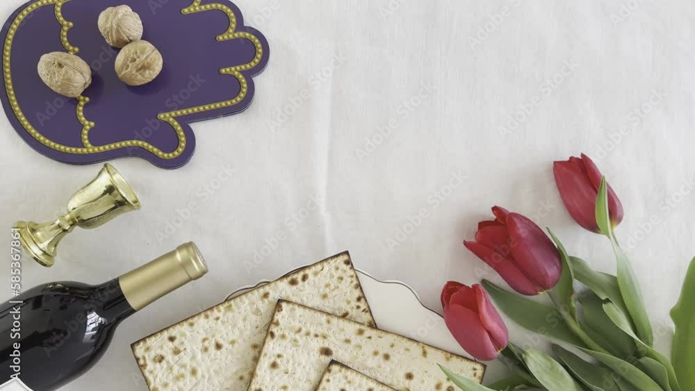 Matzah shape of heart with red tulips, bottle of wine and walnut on ...