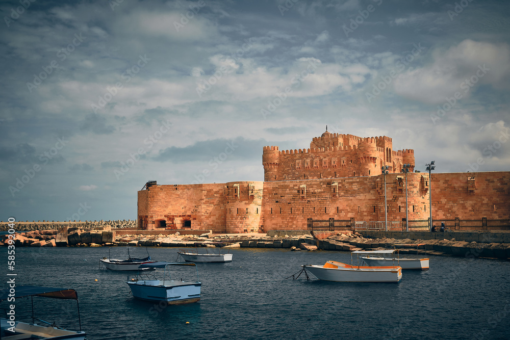 Boats in a harbor in front of Qaitbay fort. Citadel of Qaitbay ...