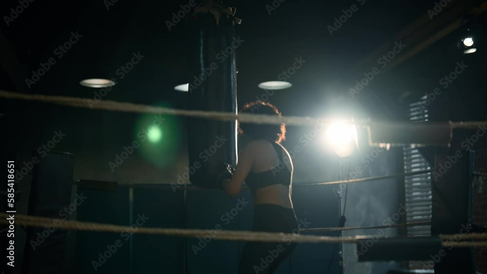Afro american woman boxer with curly hair boxing in gym on boxing ring ...