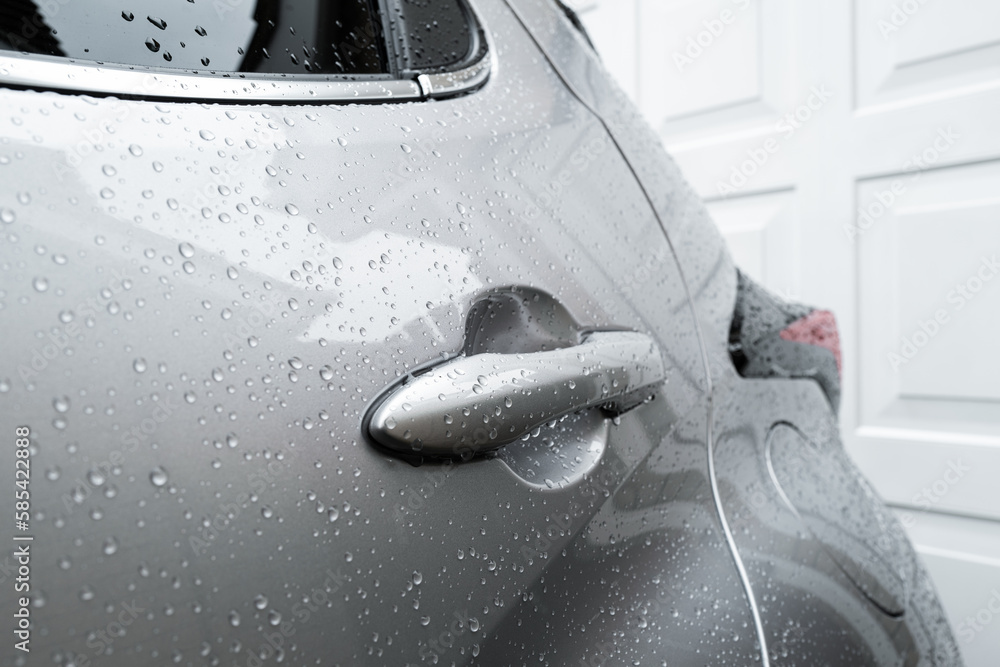 Shallow focus of the rear car door handle of a hybrid city car. Seen ...